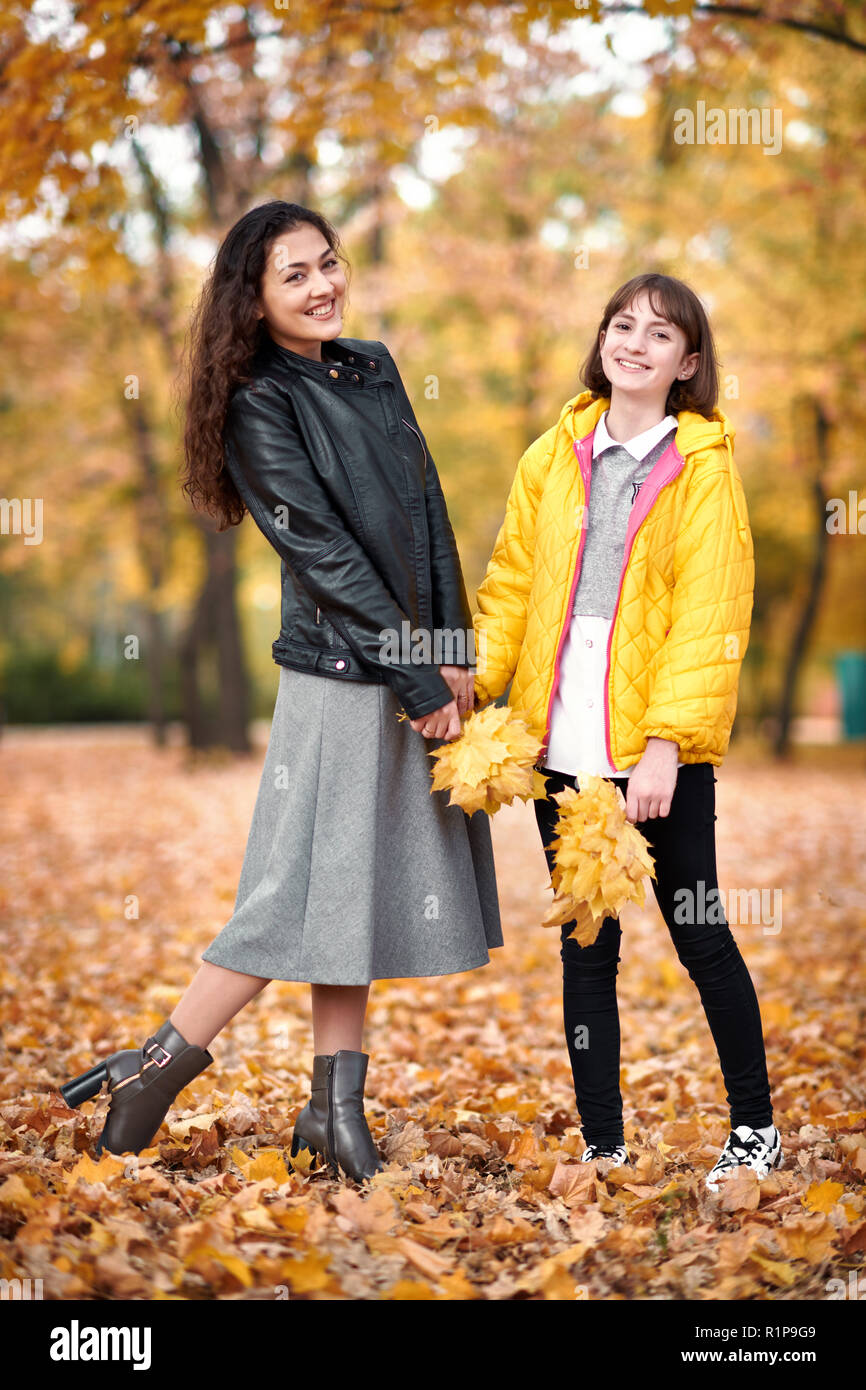 Two girls sister posing in city park hi-res stock photography and ...