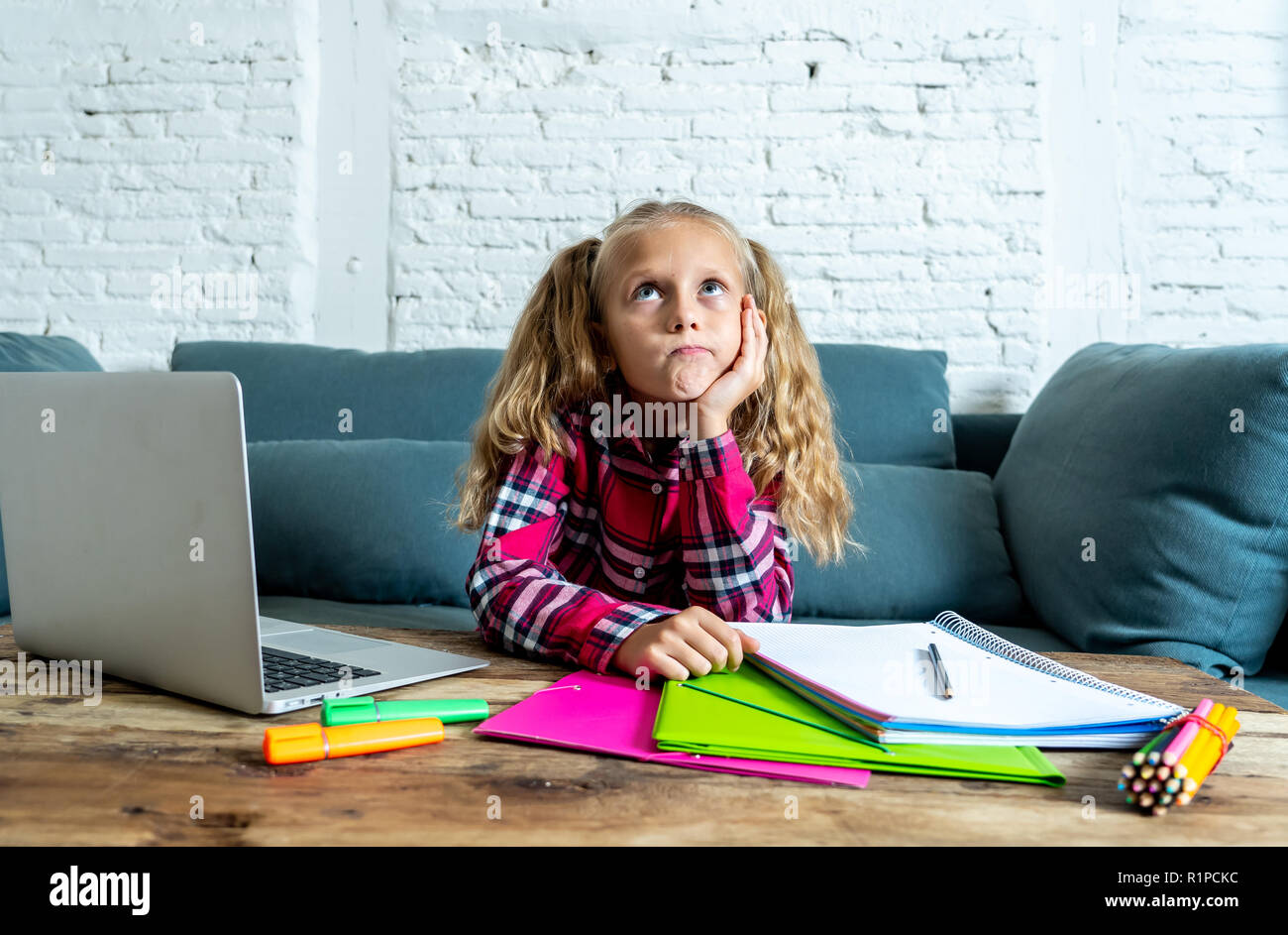 Cute elementary student feeling sad and confusing while doing difficult ...