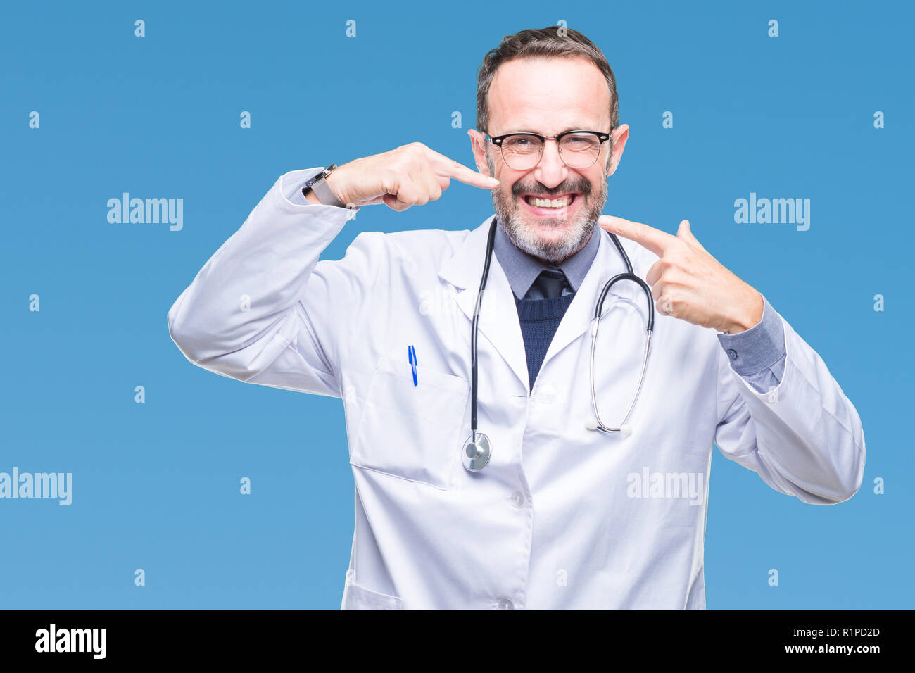 Middle age senior hoary doctor man wearing medical uniform isolated ...