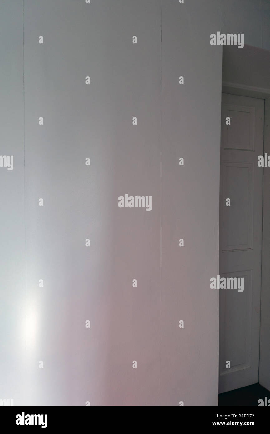 simple sheets of plain wallpaper on wall with join showing near a ...