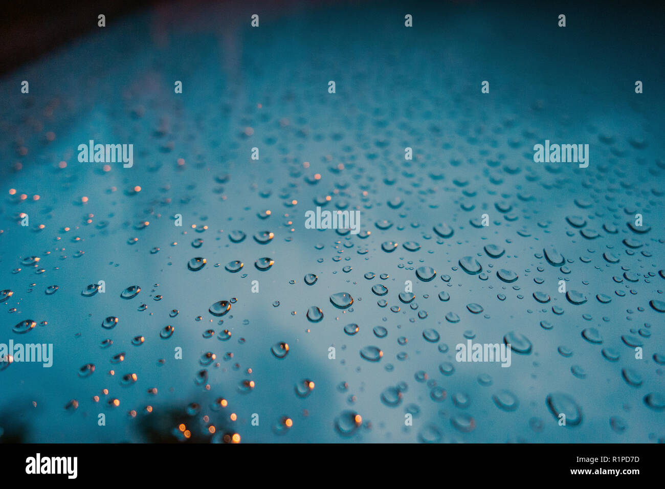 very closeup photograph of raindrops on glass window with dark sky in ...