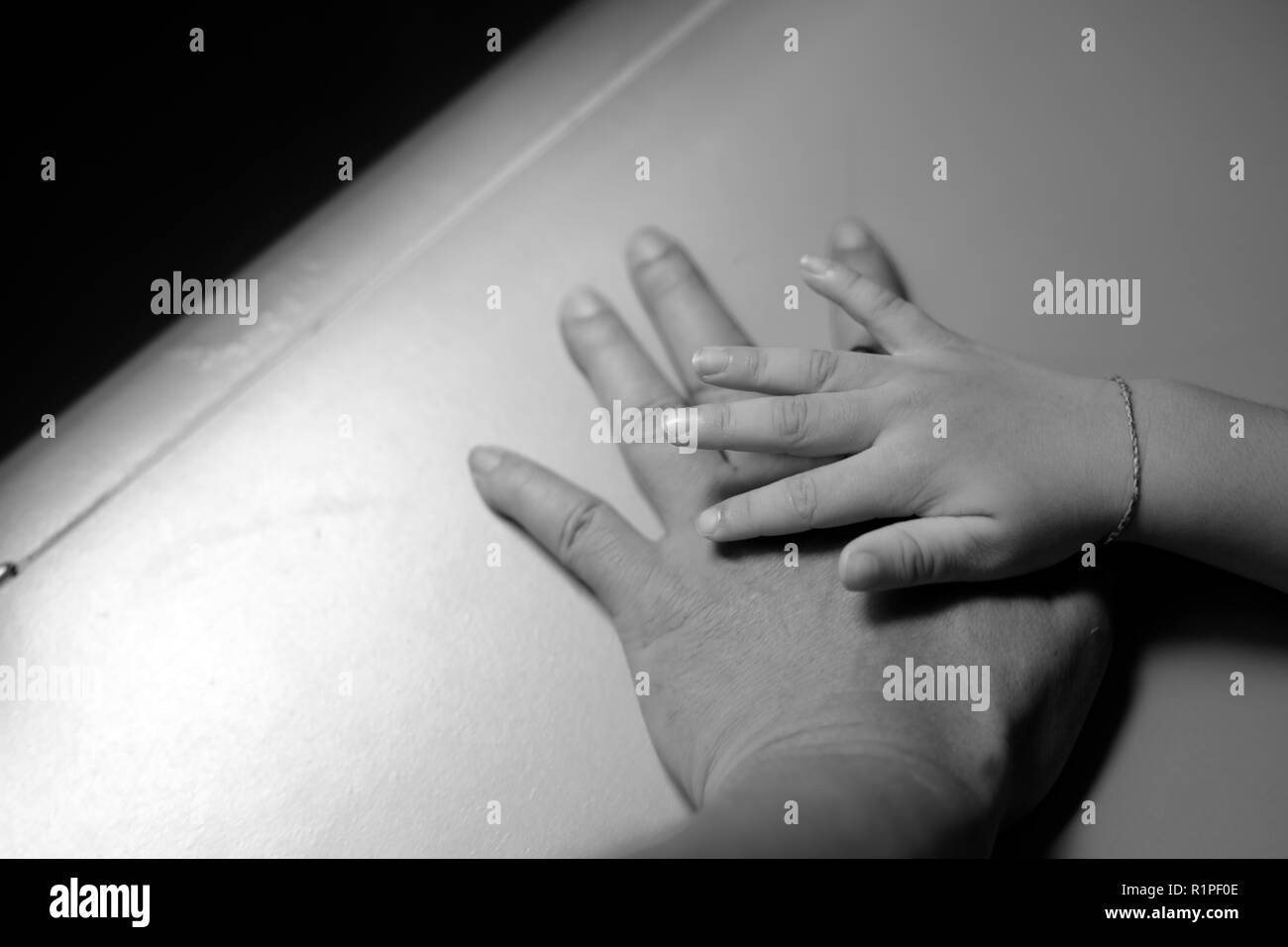 young kid hand on father hand Stock Photo - Alamy