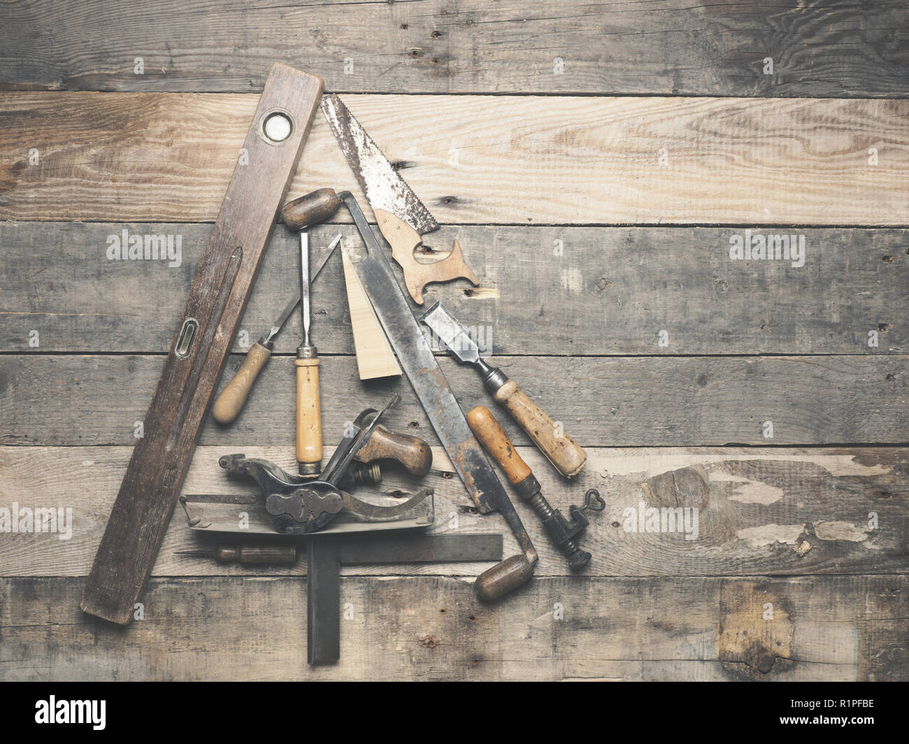 Vintage carpenter tools as a Christmas tree on an old rustic wooden ...