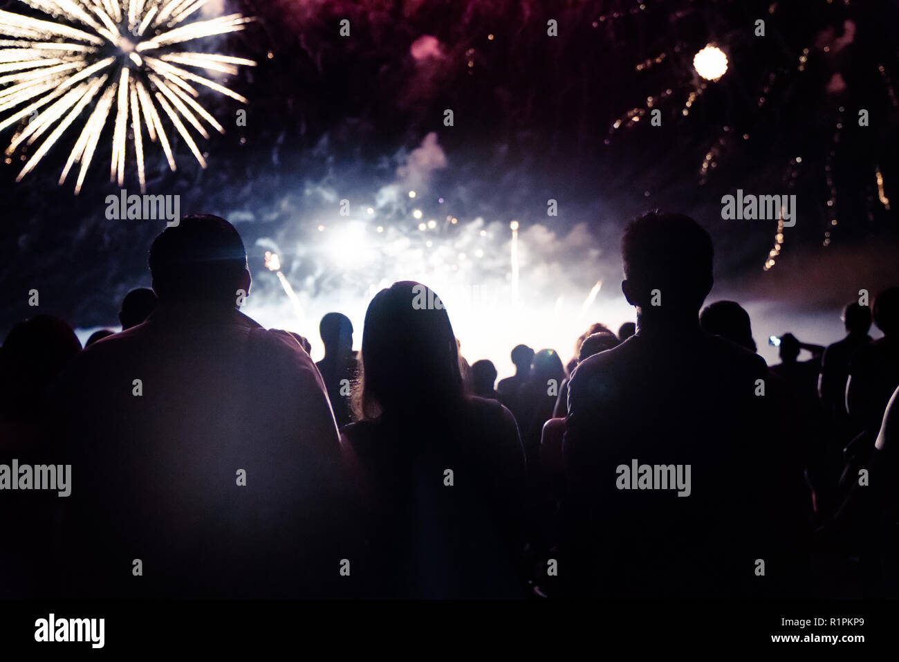 Crowd watching fireworks and celebrating new year eve Stock Photo - Alamy