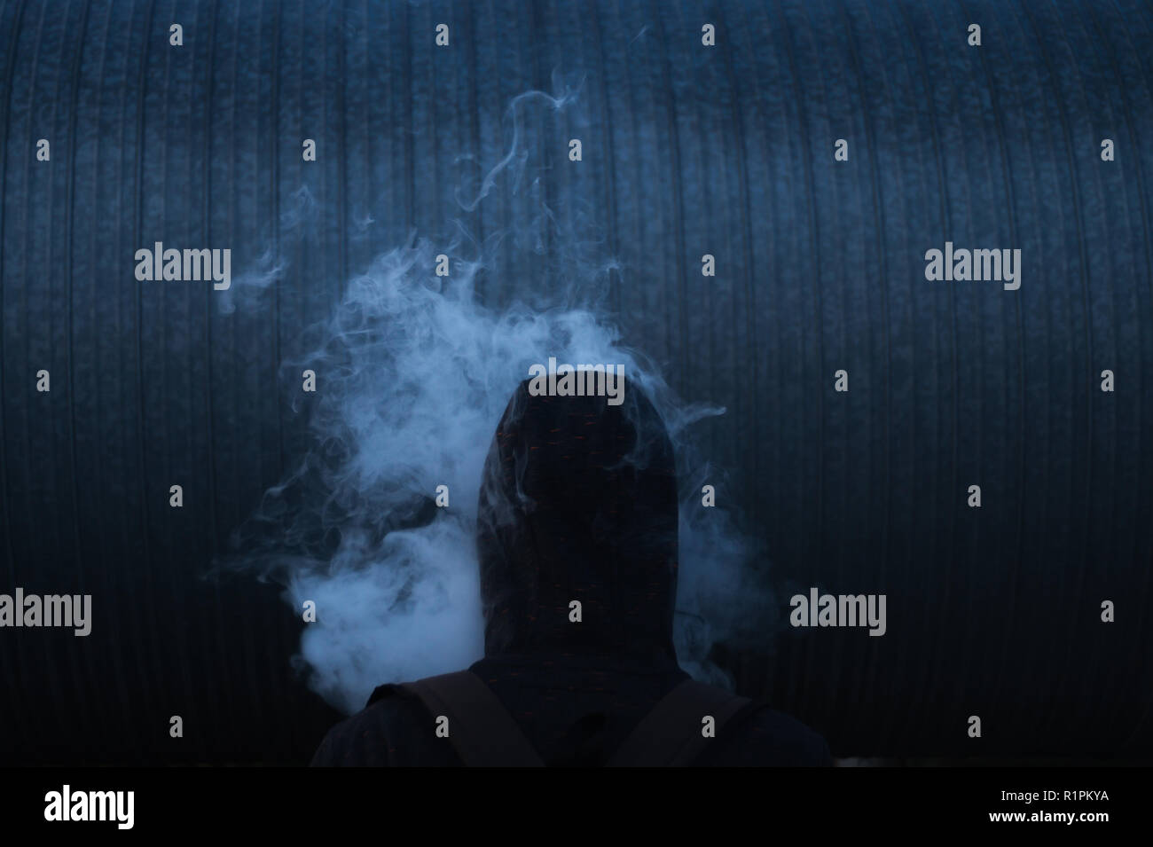 Man in smoke on the dark background Stock Photo - Alamy