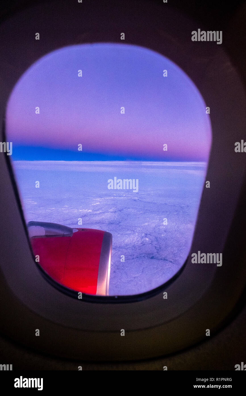 Airplane window looking out over the wing and engine on an Iberia ...