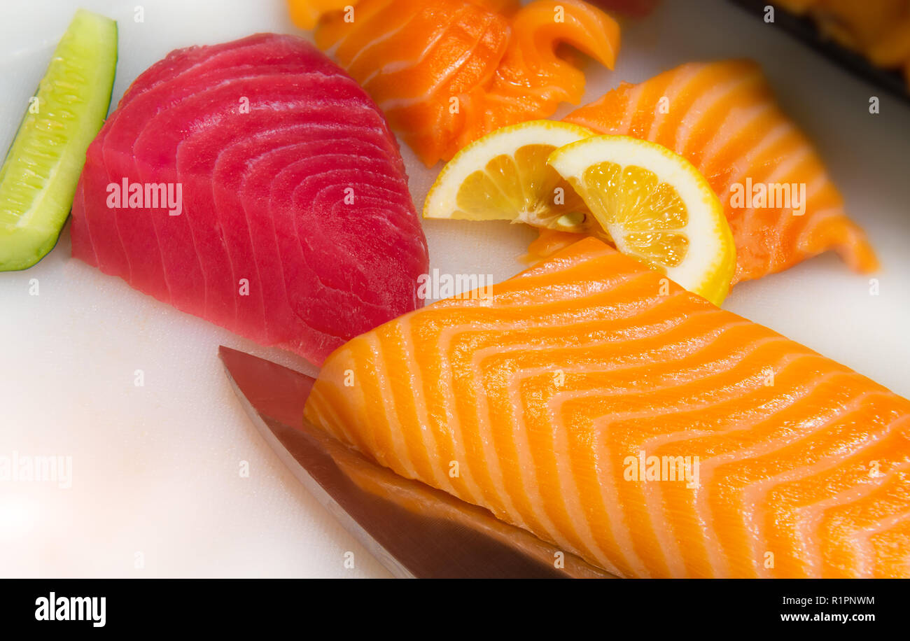 Salmon cutting preparing for cooking in the kitchen with another ...