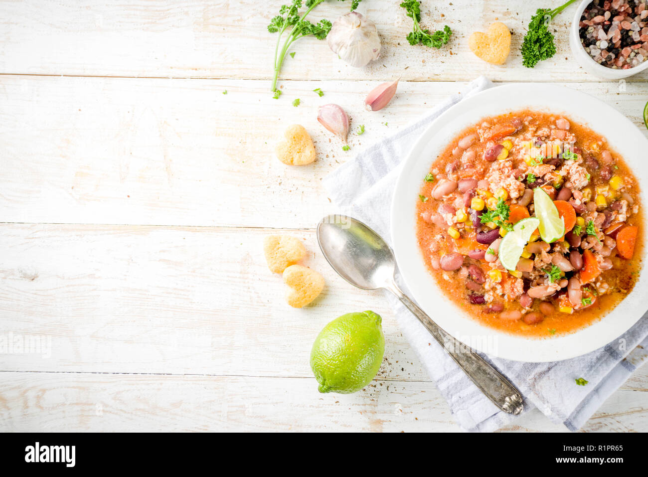 Chili con carne in plate on white wooden background. Mexican chili with ...