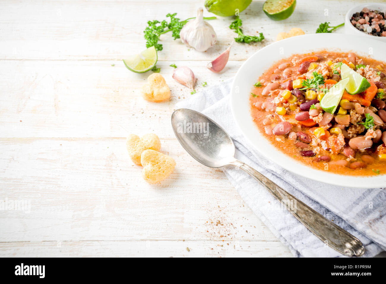 Chili con carne in plate on white wooden background. Mexican chili with ...