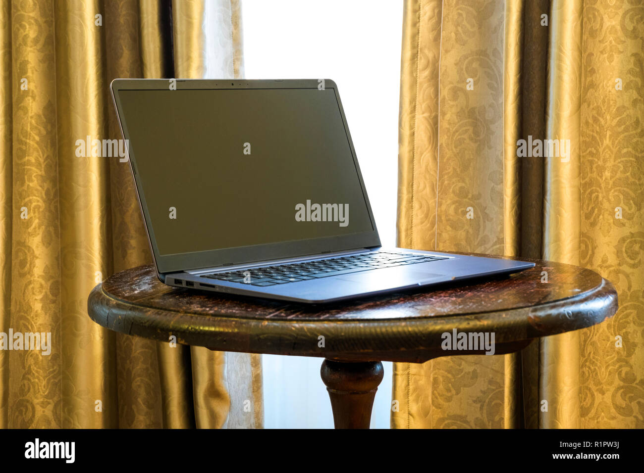 Elegant lightweight laptop on vintage wooden table with blank screen ...