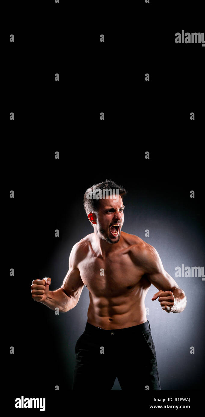 Dramatic portrait of strong boxer and macho man enjoys success with his ...