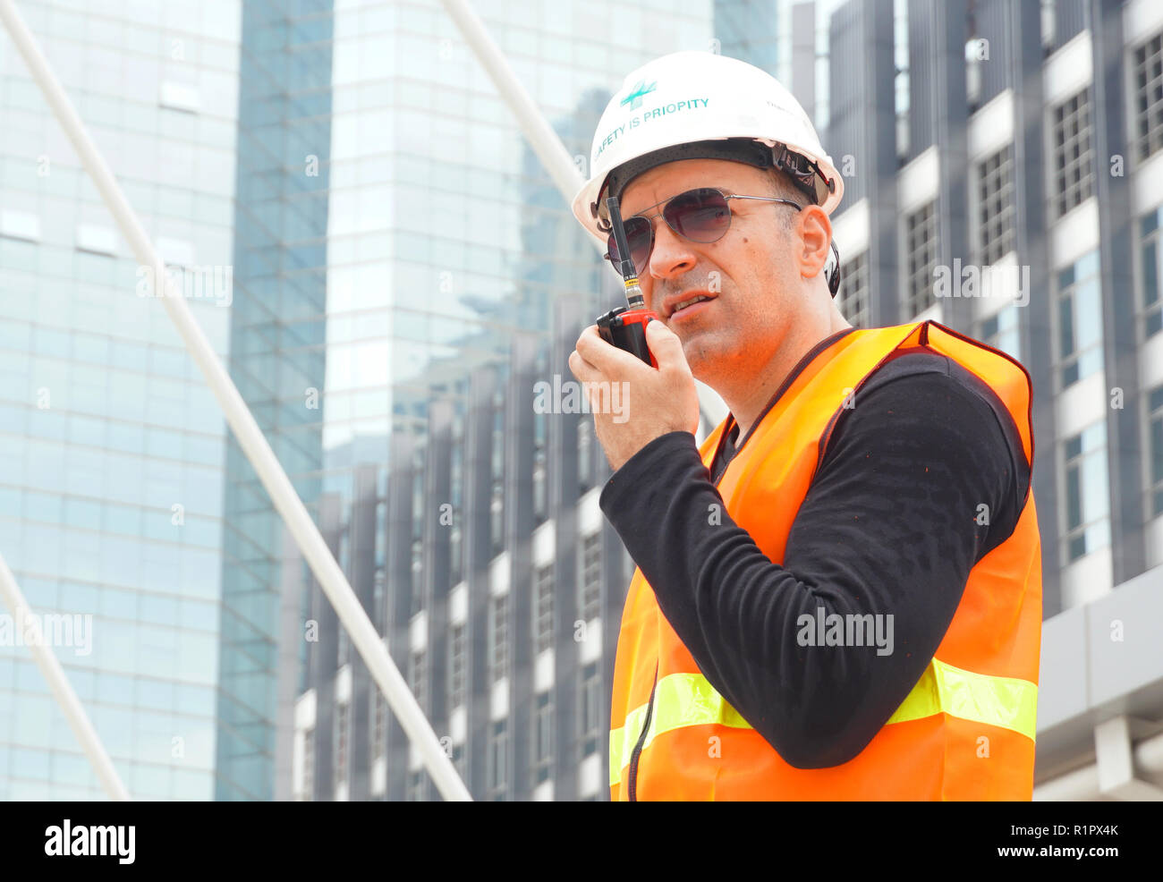 Engineer wear helmet and use radio communication for job control at ...