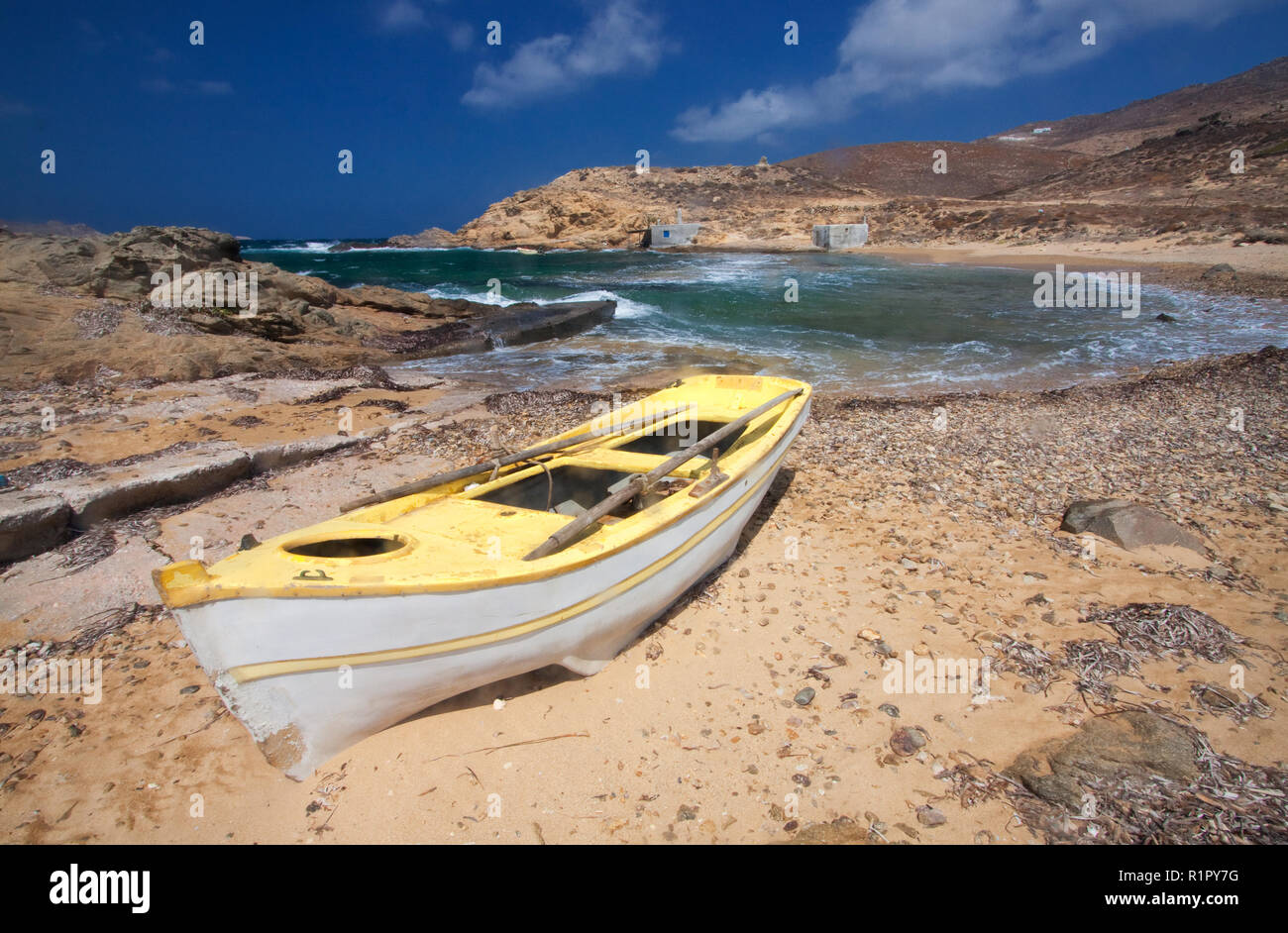 A small rowing boat on the beach at Ftelia bay, Mykonos Stock Photo - Alamy