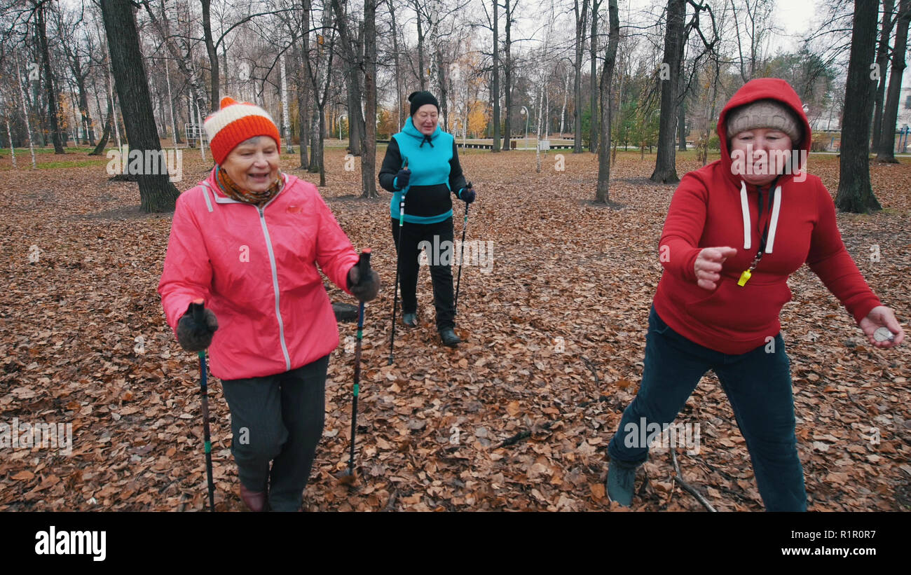 Two elderly women running on sticks of nordic walking Stock Photo - Alamy