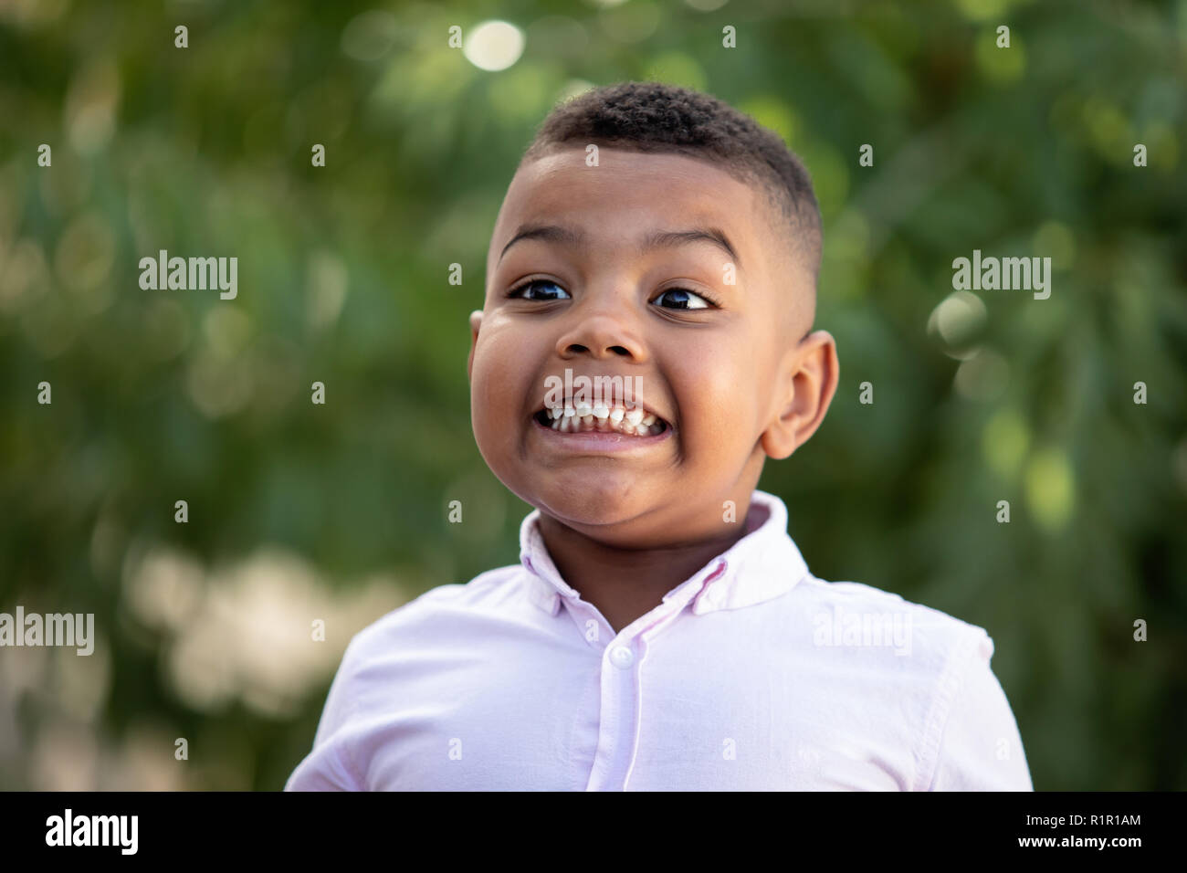 Funny latin child in a park, laughing with a funny expression Stock ...