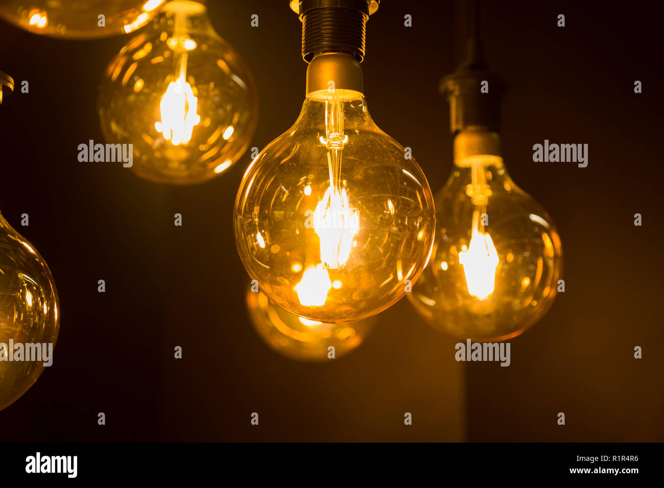 Cozy warm yellow light. Edison light bulb hanging. Closeup Stock Photo ...