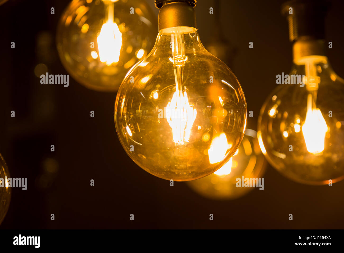 Cozy warm yellow light. Edison light bulb hanging. Closeup Stock Photo ...