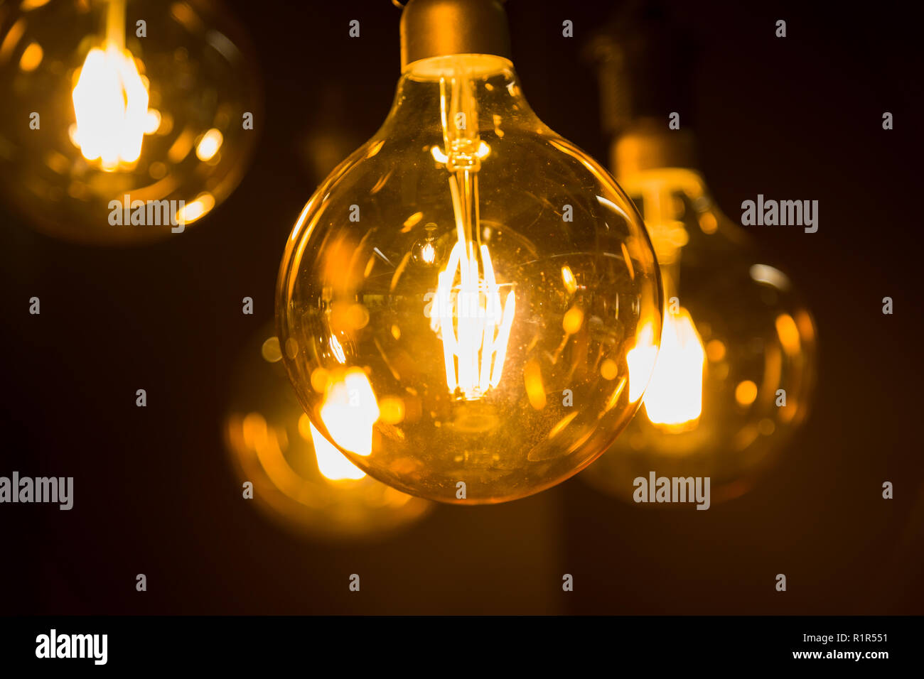 Cozy warm yellow light. Edison light bulb hanging. Closeup Stock Photo ...