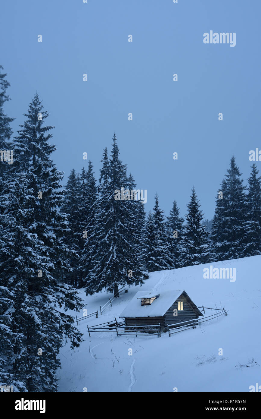 Christmas landscape with footpath in the snow. Wooden house on a ...