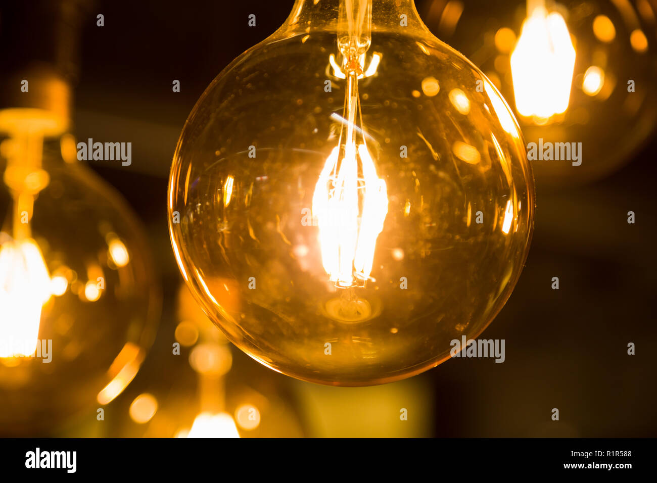Cozy warm yellow light. Edison light bulb hanging. Closeup Stock Photo ...