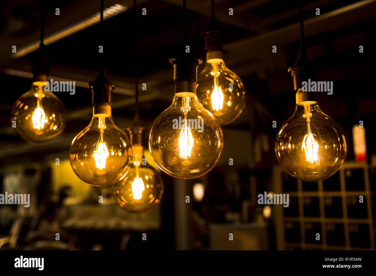 Cozy warm yellow light. Edison light bulb hanging. Closeup Stock Photo ...