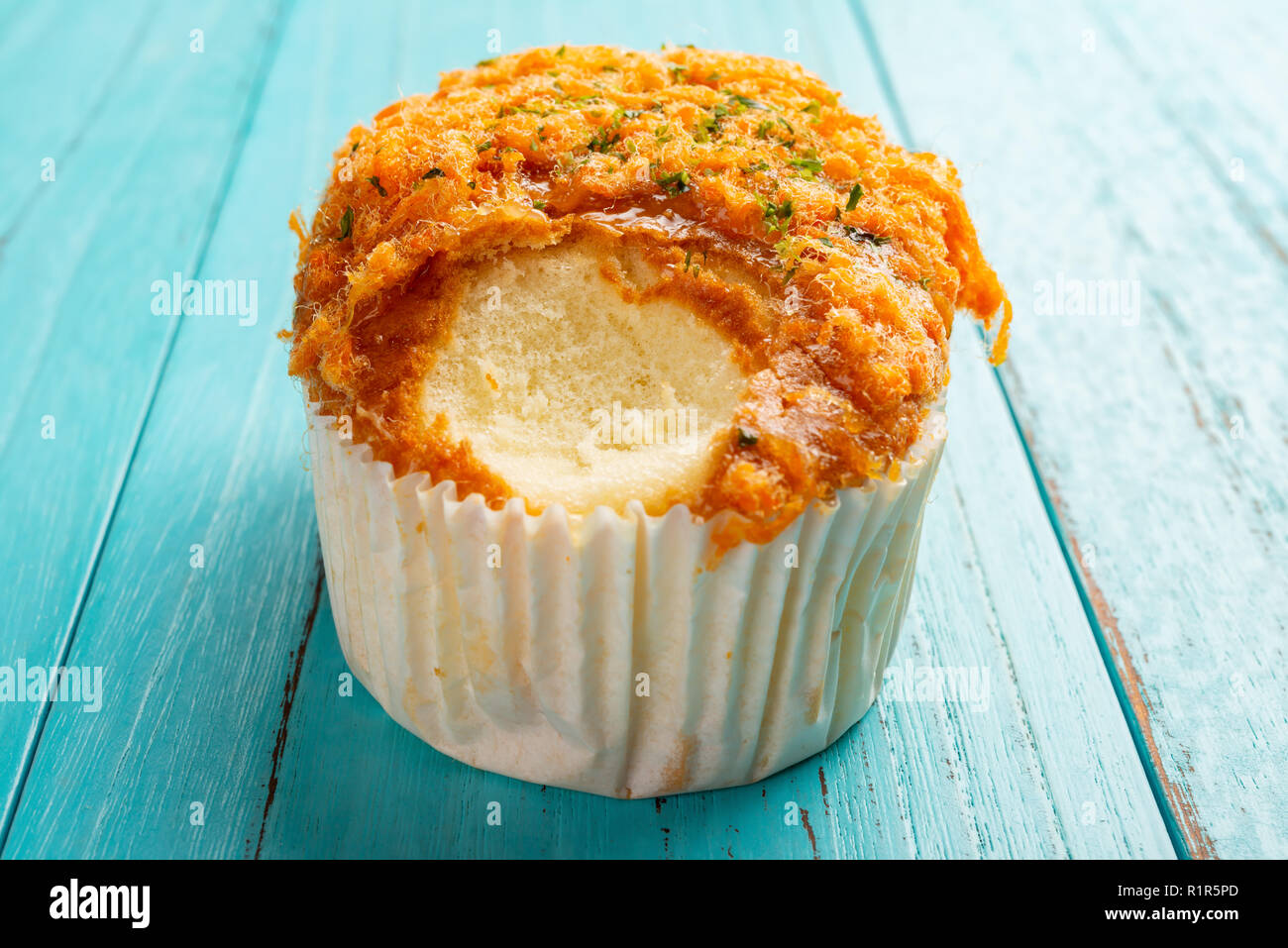 front view shredded pork bread with a bite on blue wood background ...