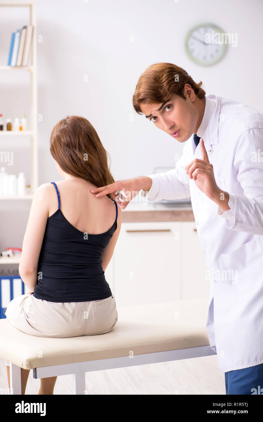 Female patient visiting young handsome doctor chiropractor Stock Photo ...