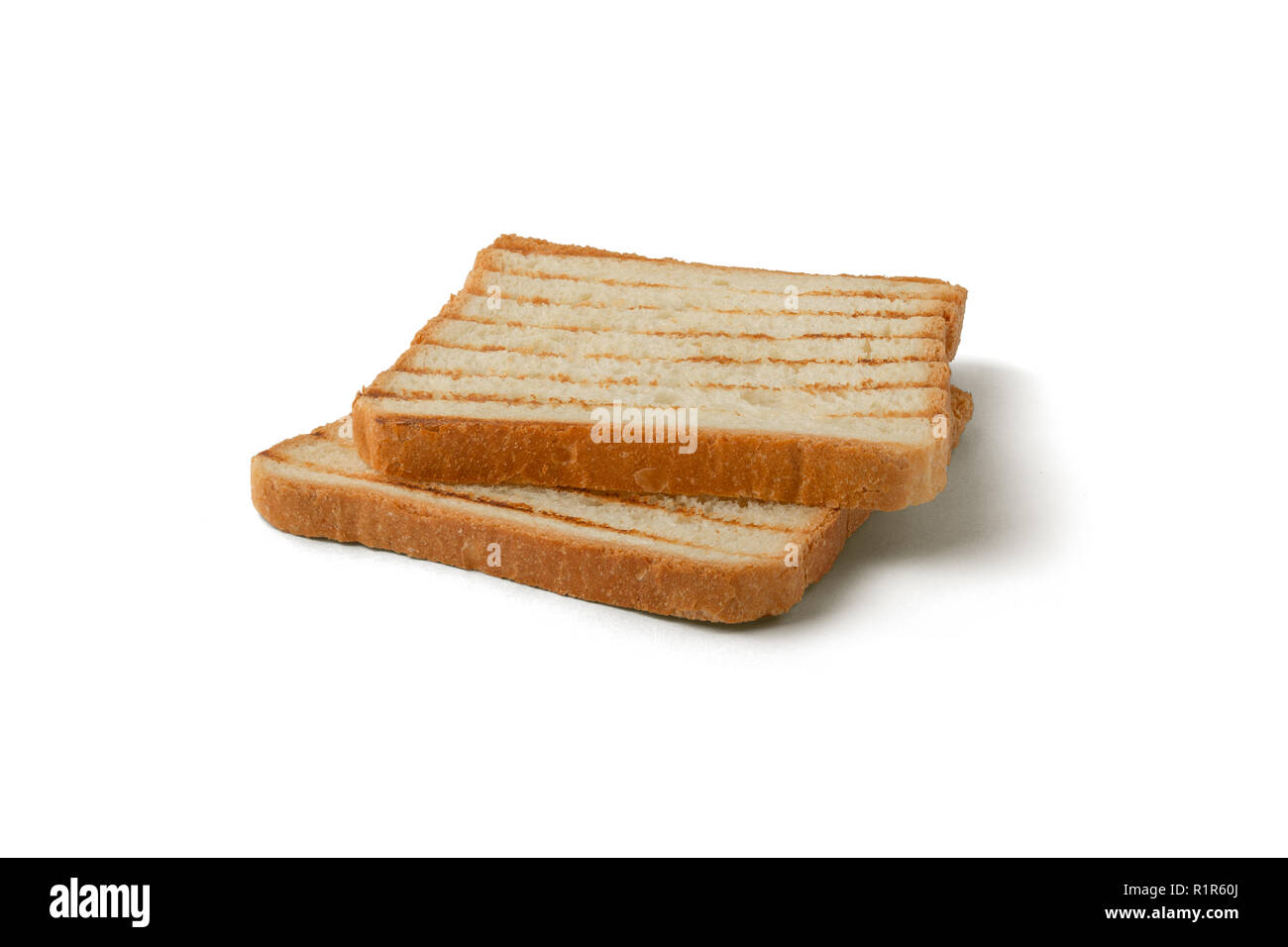 Slices of toast bread grilled with a golden crust isolated on white ...