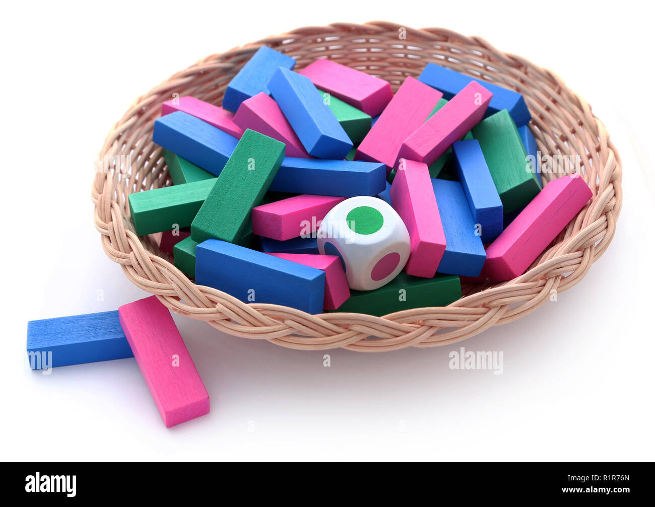 Jenga game of colorful wooden blocks with dice over white background ...
