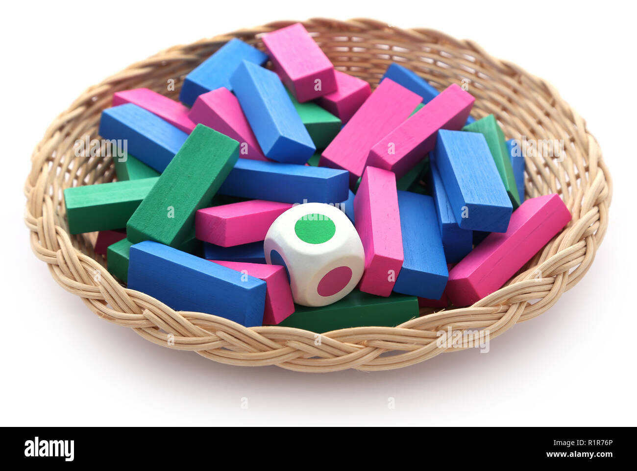 Jenga game of colorful wooden blocks with dice over white background ...