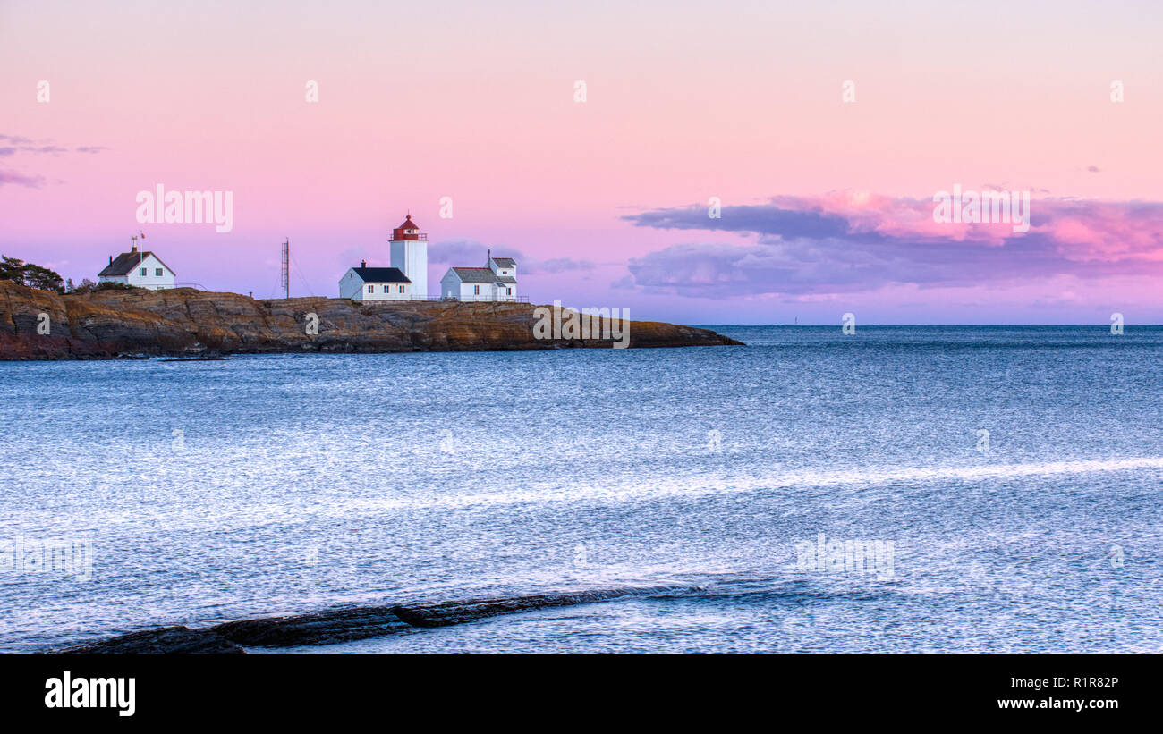 The wild coast of Norway at a sunset. The Fjord of Langesund with the ...