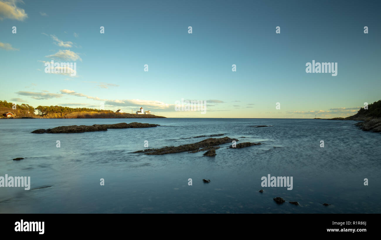 The wild coast of Norway at a sunset. The Fjord of Langesund with the ...