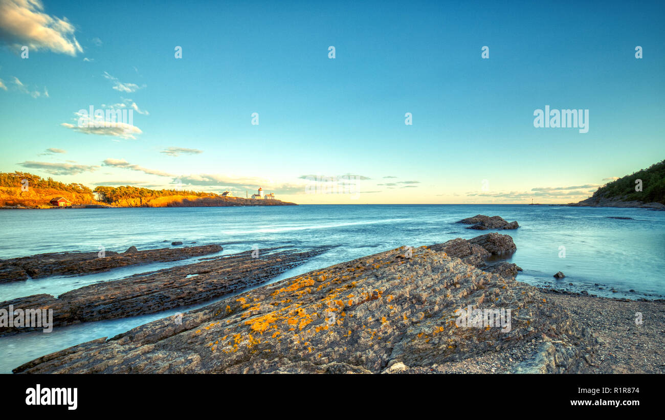 The wild coast of Norway at a sunset. The Fjord of Langesund with the ...