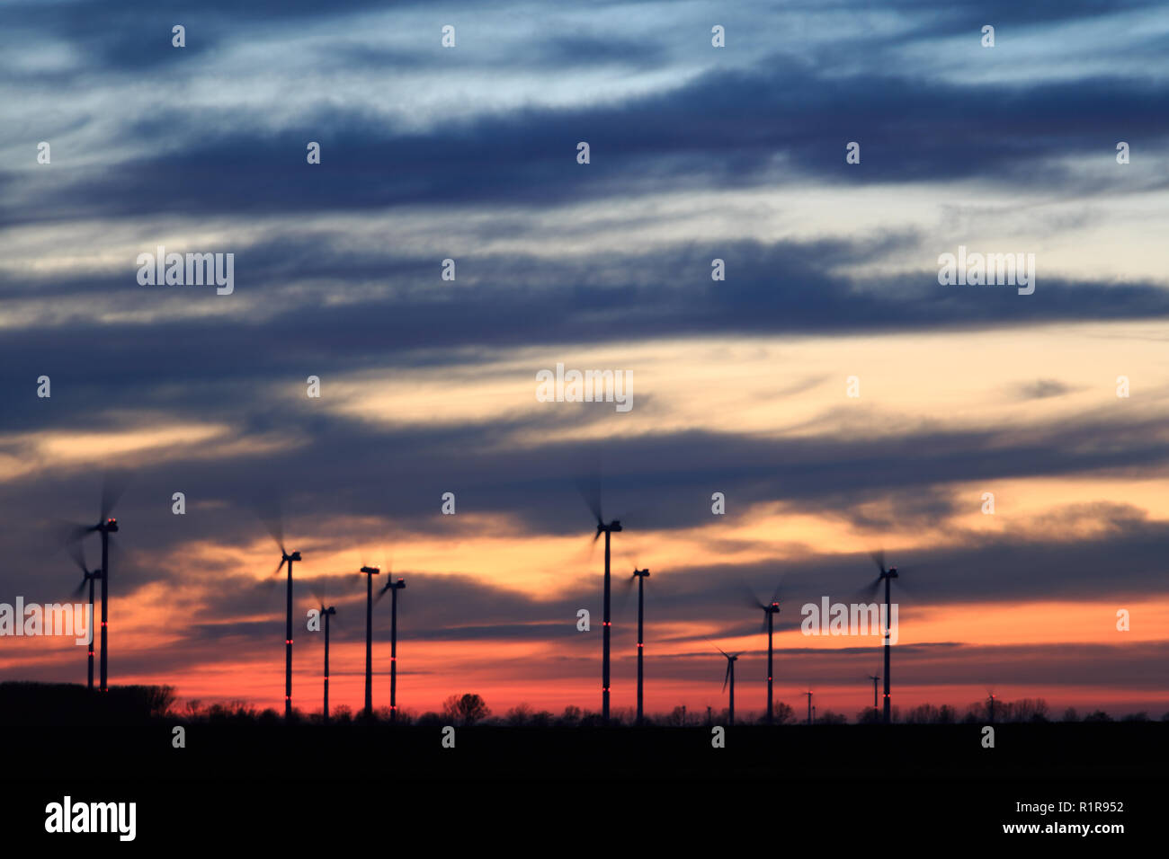sunset landscape with red horizon and wind power energy Stock Photo - Alamy