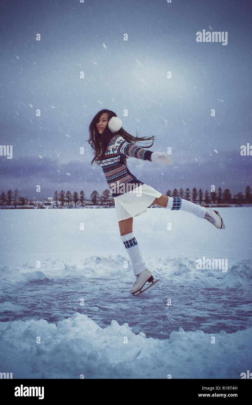 Girl skating outdoors at winter with snow Stock Photo - Alamy