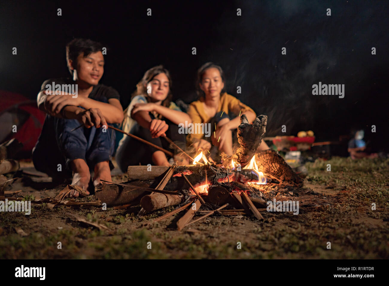 group of friends having fun camping, enjoy the camp fire Stock Photo ...