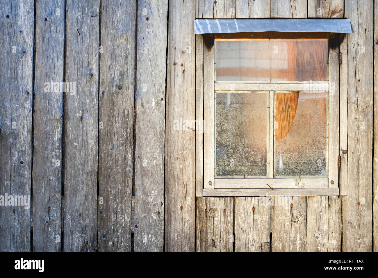 Wooden background. Wall of a barn with a broken window Stock Photo - Alamy