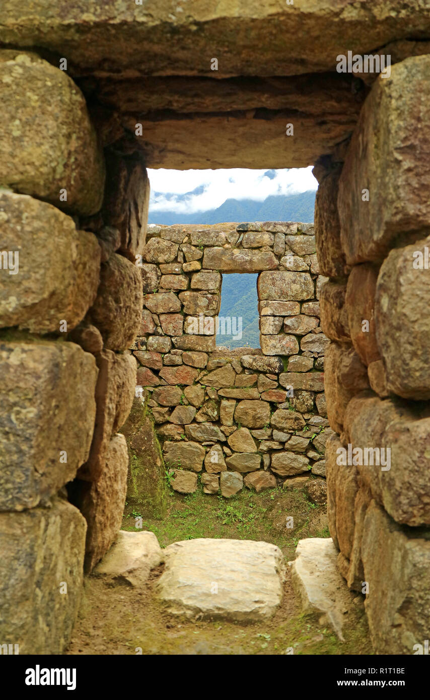 Ancient doorway with the remains of the Incas and the mountain ranges ...
