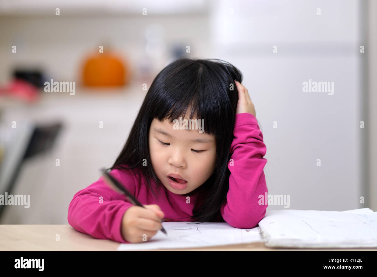 Child writing with pencil hi-res stock photography and images - Alamy