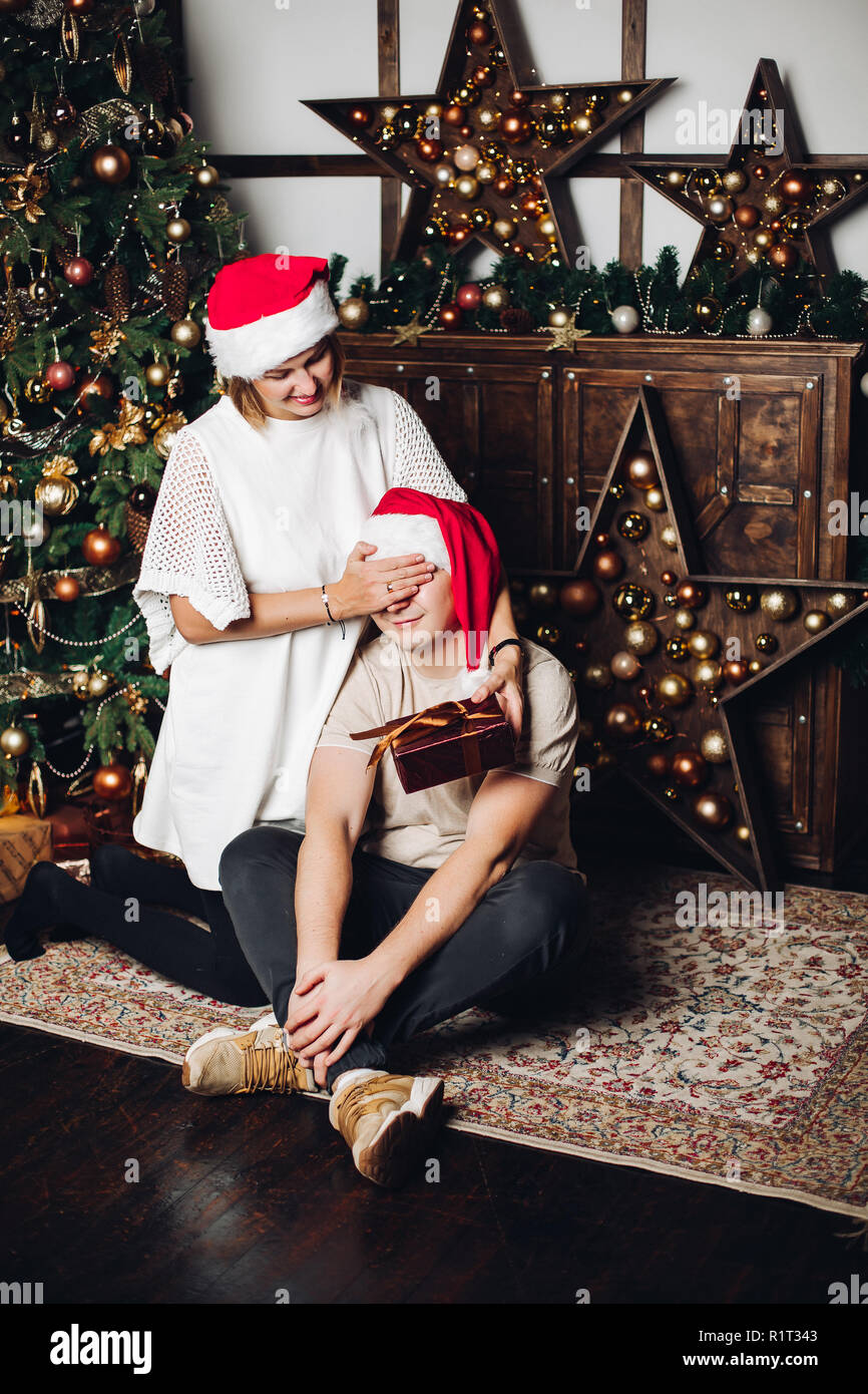 Wife presenting a gift to her husband Stock Photo - Alamy