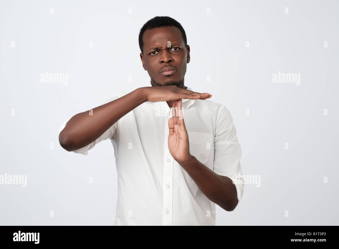 Portrait of worry pleading handsome african young man in white shirt ...
