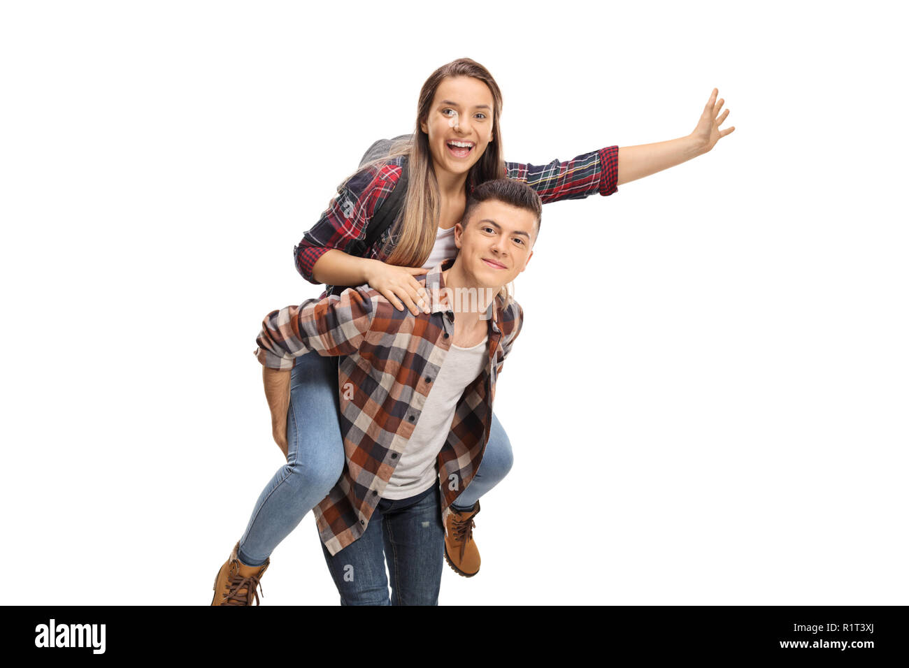 Teenage boy carrying a teenage girl on his back isolated on white ...