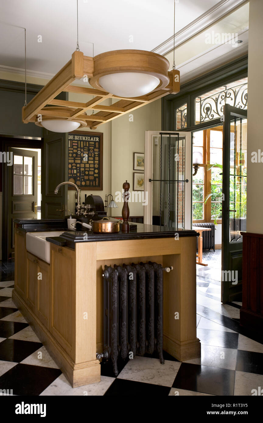 Wooden kitchen unit with radiator Stock Photo - Alamy
