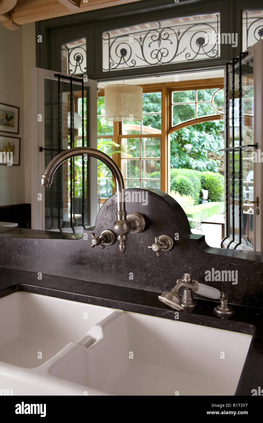 Kitchen sink by open doors Stock Photo - Alamy