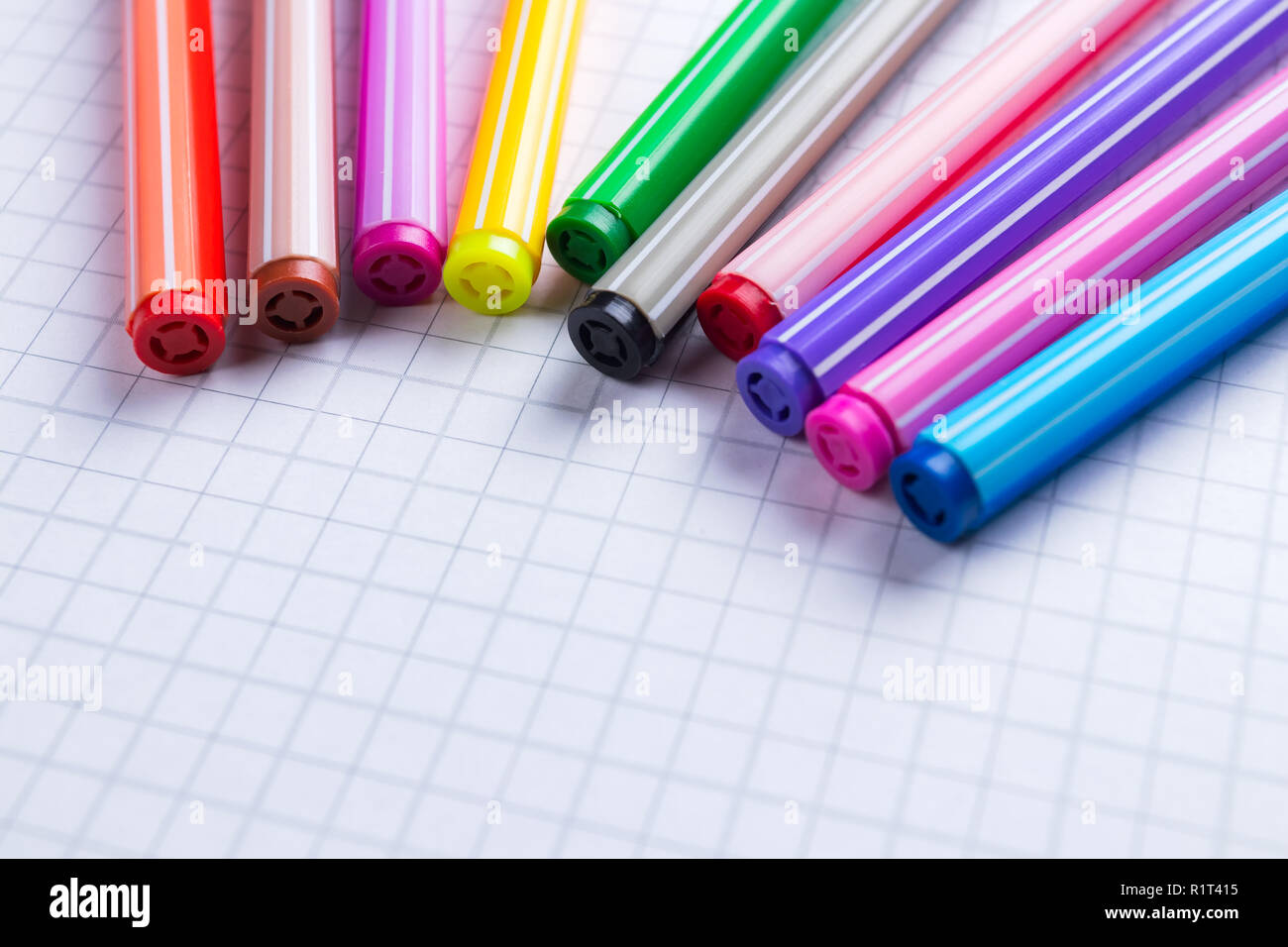 Colorful pens on sheet of squared paper. Education abstract concept ...