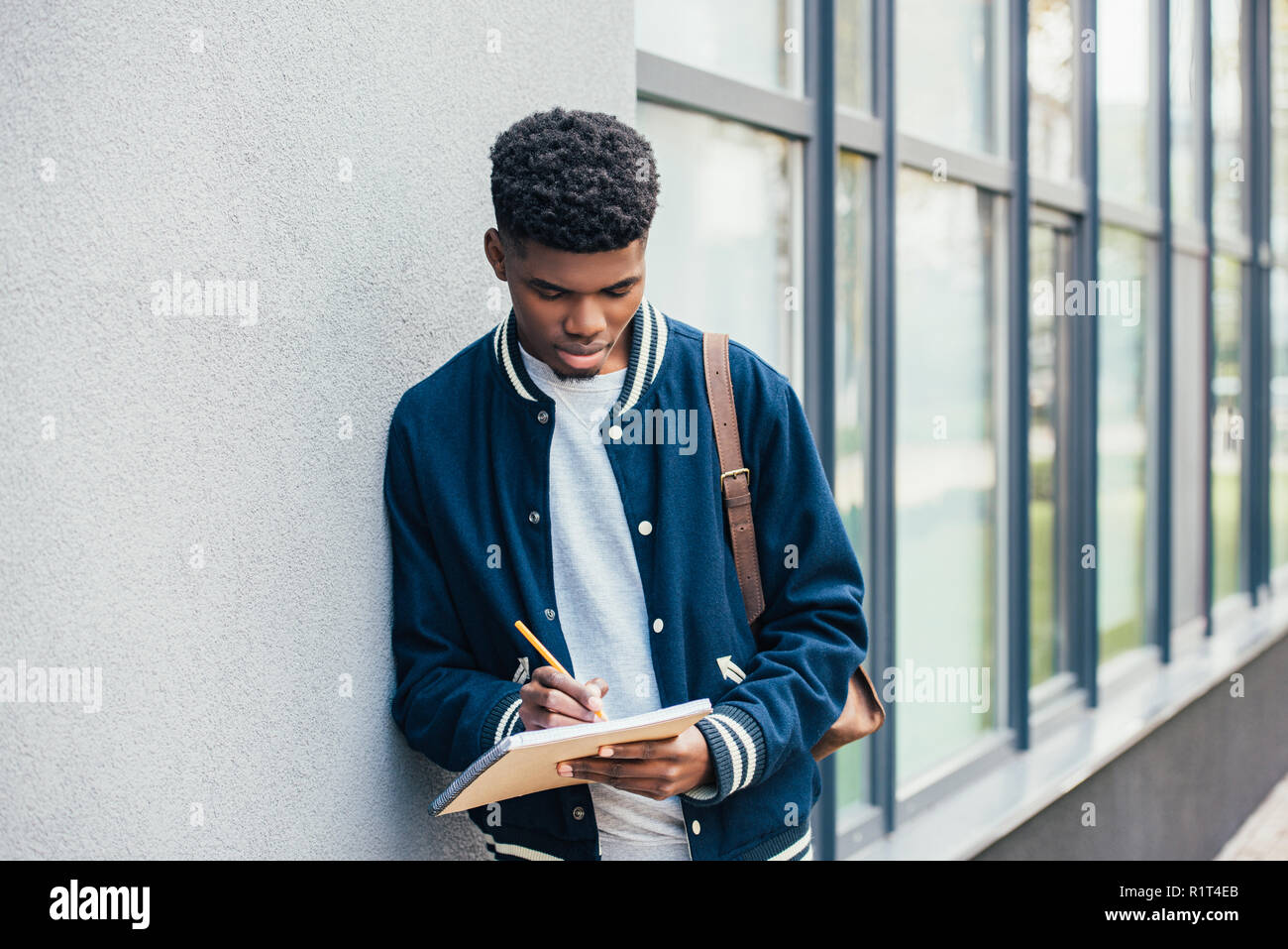 concentrated young african american student writing in textbook Stock ...