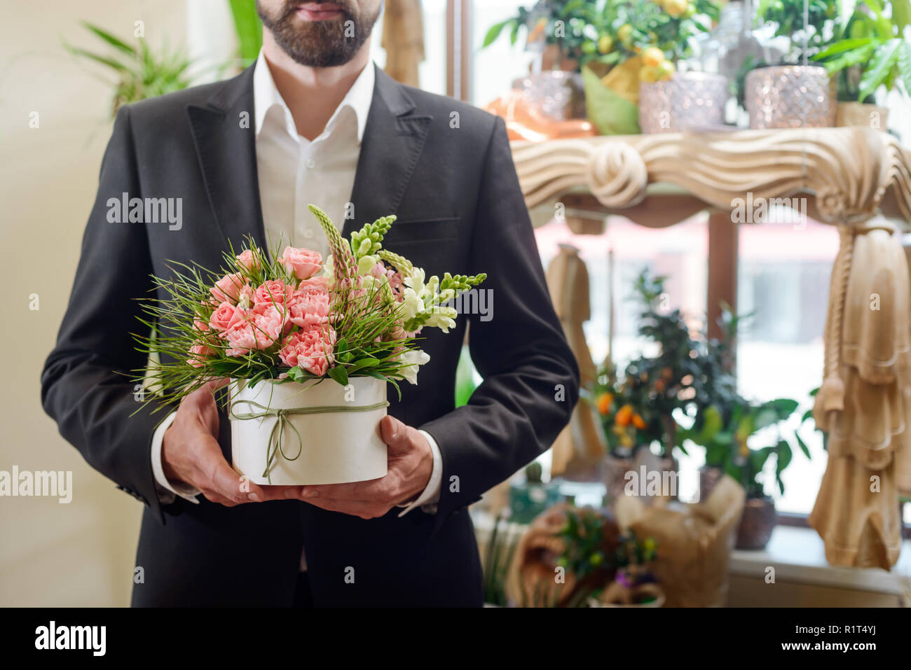 Flower box in male hands Stock Photo - Alamy