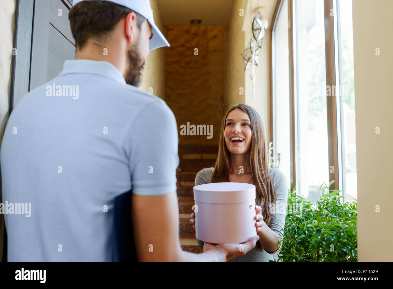 Deliveryman giving an order Stock Photo - Alamy