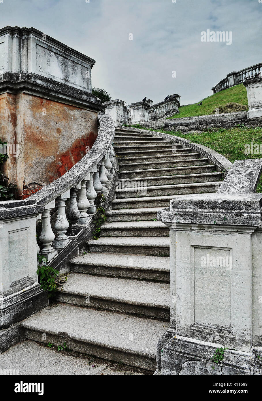 Vintage grey stone steps, Gray old brick wall, green grass, blue sky ...