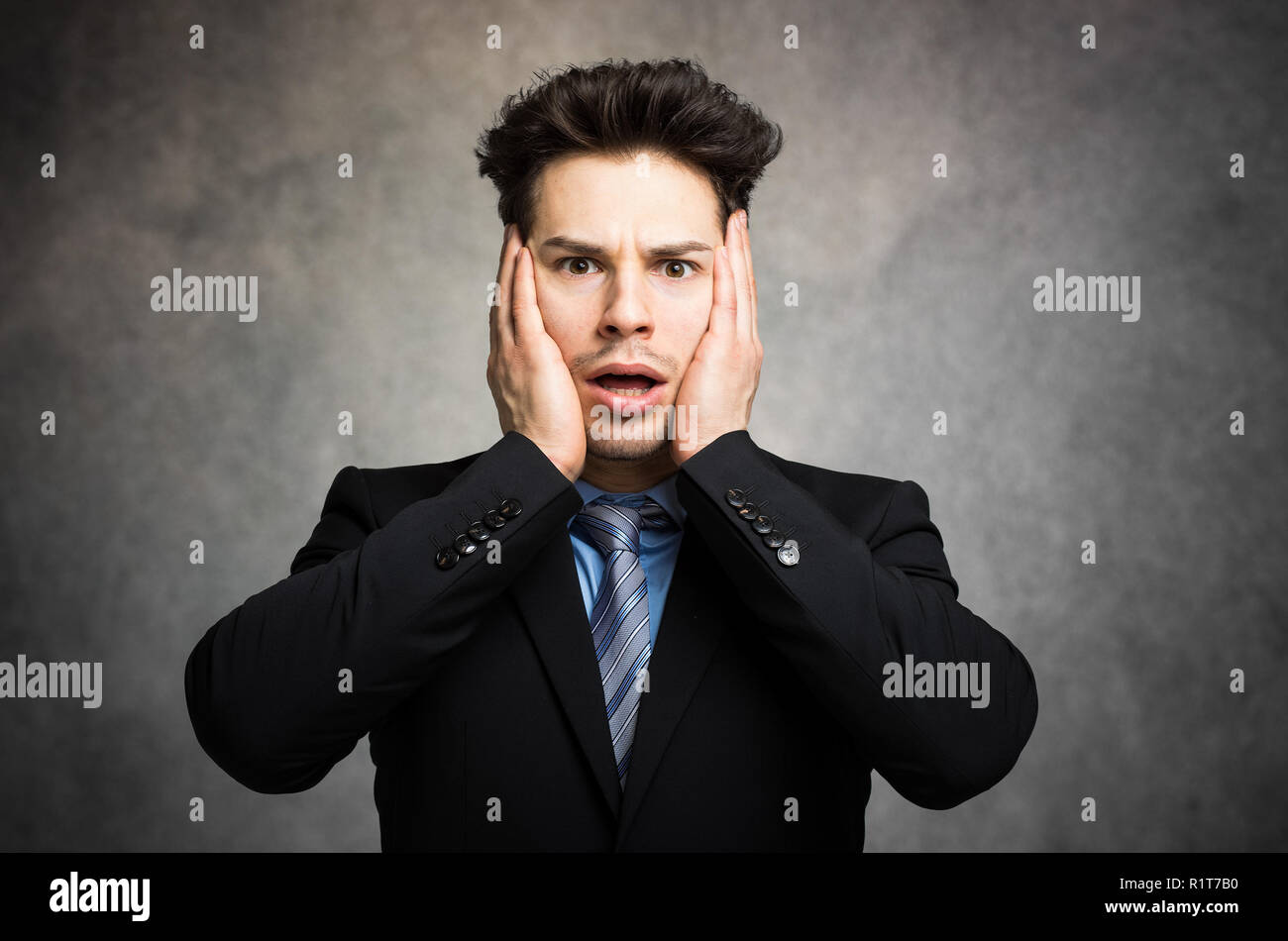Young businessman in a shocked expression Stock Photo - Alamy